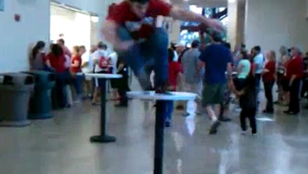Guy attempts to jump over table, fails miserably - CBS News