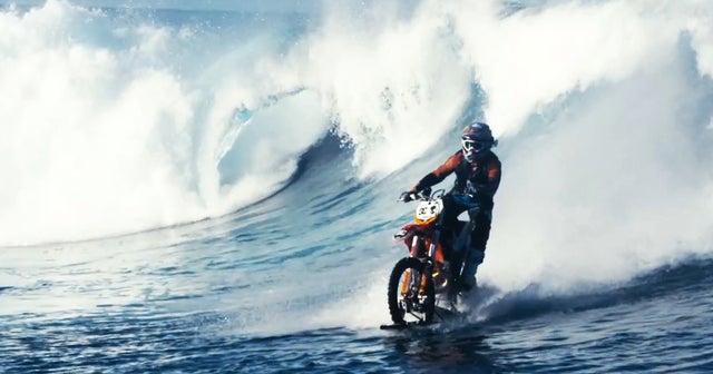 Motocross rider surfs ocean waves on a dirt bike - CBS News