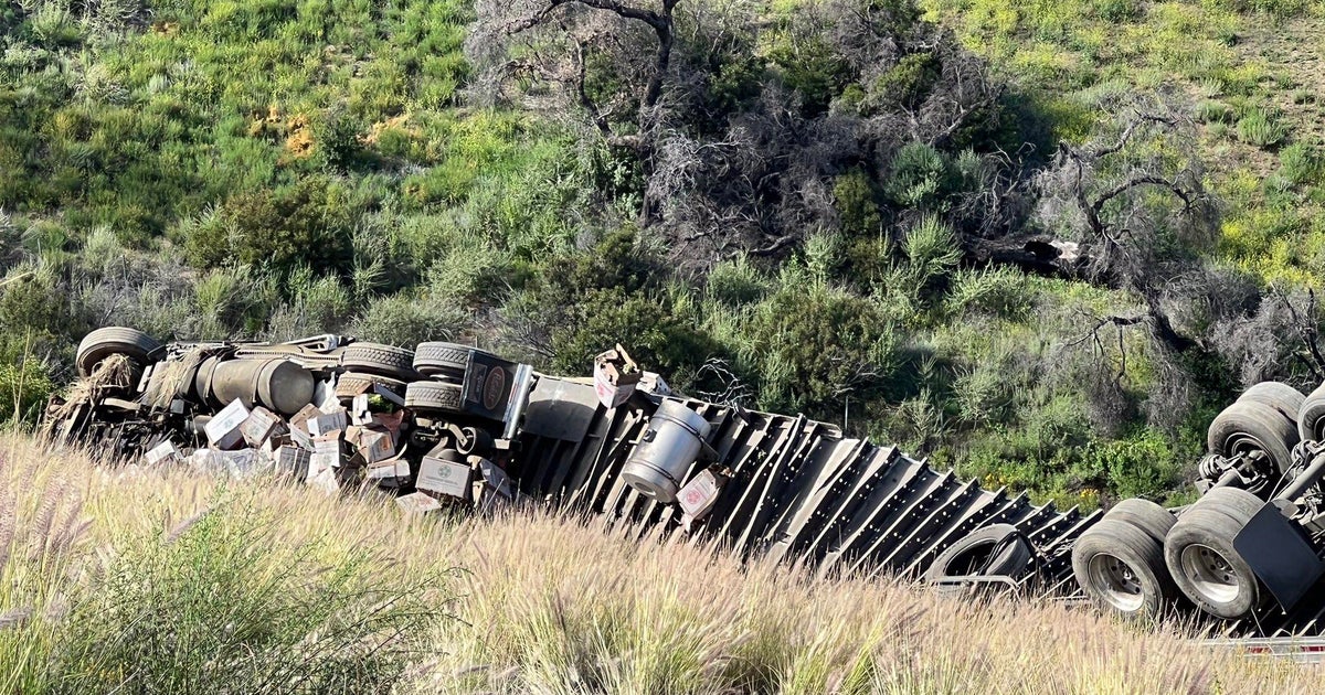 Big rig remains stuck for hours after crashing through guardrail on 118 ...